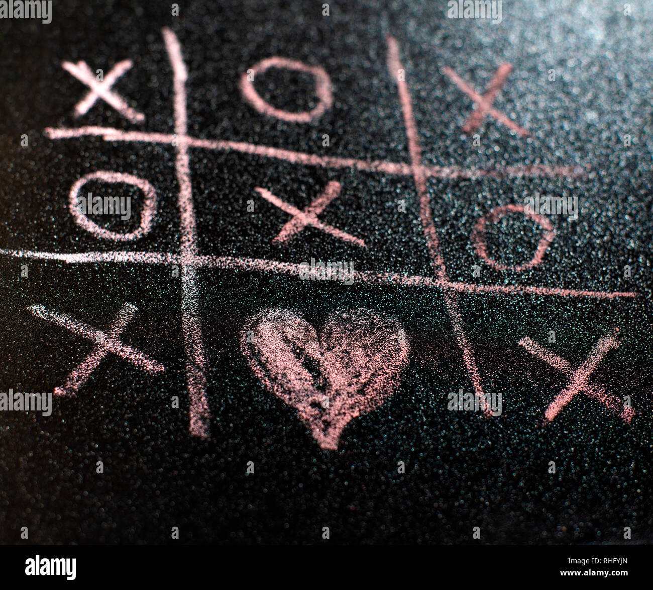Tic-tac-toe game on black board. Valentines day concept with tic tac ...