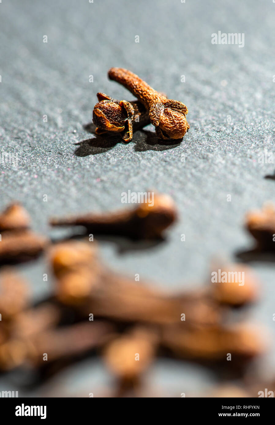 Dried Cloves on dark stone background. Natural hard light. Spice cloves ...