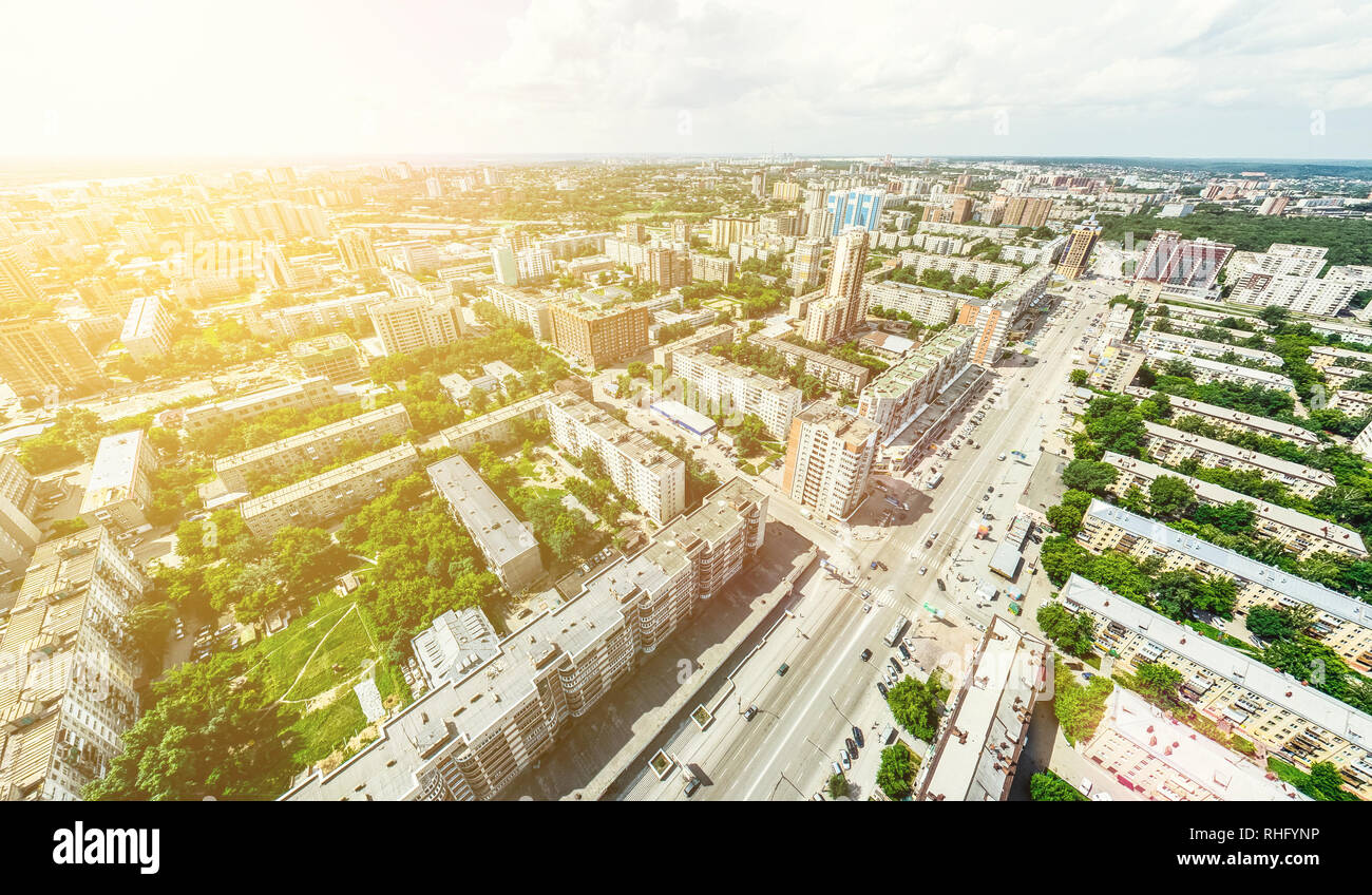Aerial city view with crossroads and roads, houses, buildings, parks ...