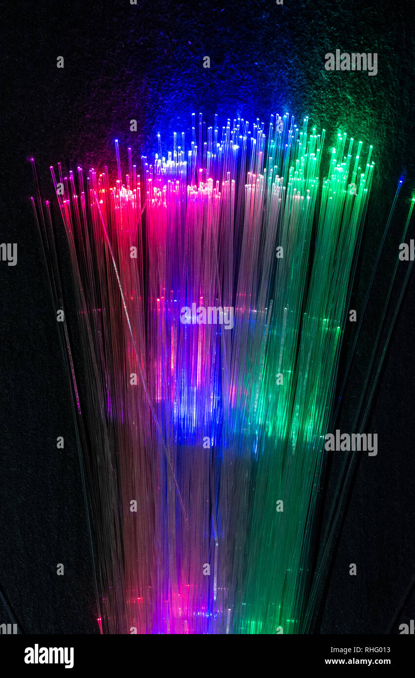 Colourful optic fibers illuminated on dark background. High speed ...