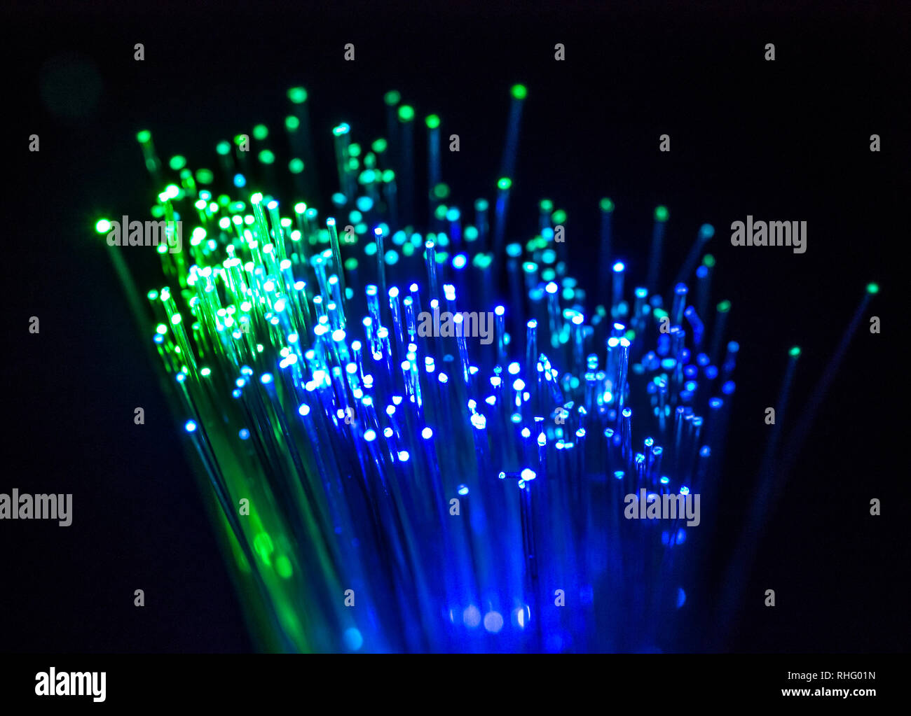 Colourful optic fibers illuminated on dark background. High speed ...