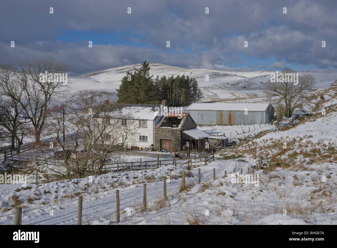 Farmhouse covered by snow in the winter in the hills in Ceredigion ...
