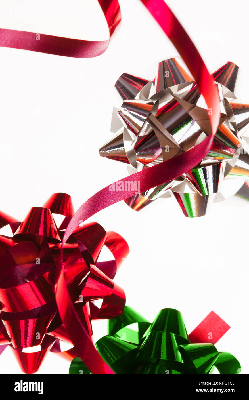 Shiny reflective Christmas present bows and ribbon on white background ...