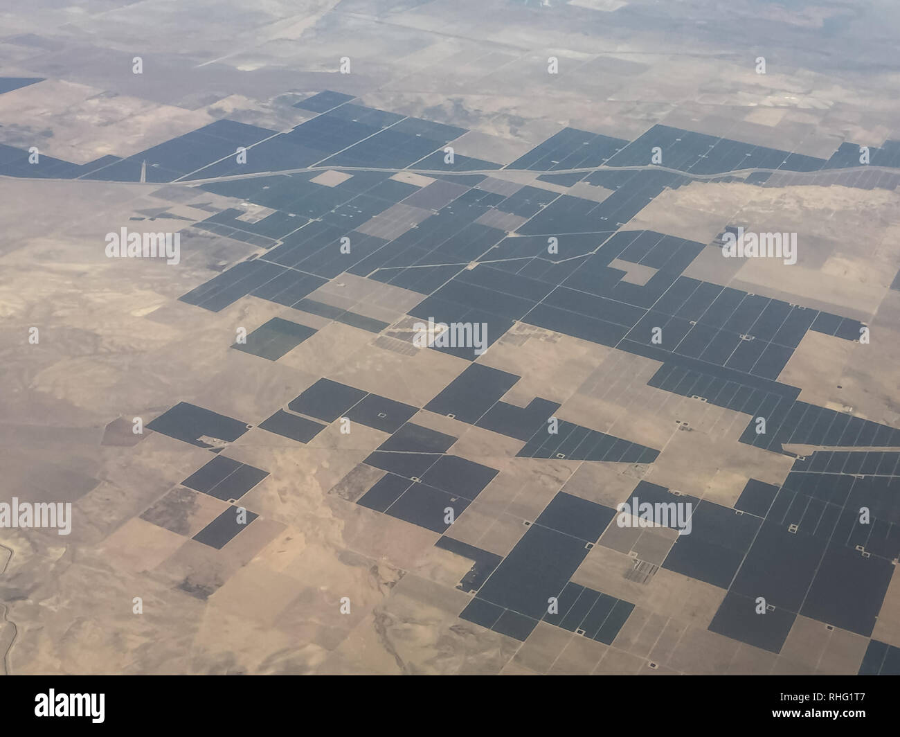 Aerial view of clearly defined fields, remote farms, dry terrain and ...