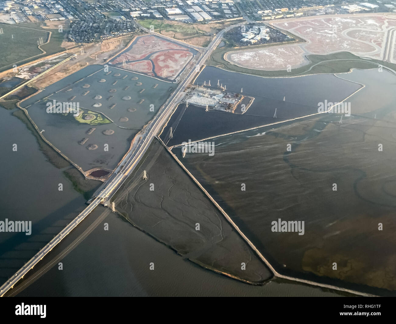 An aerial view shows a bridge crossing over a body of water, with ...