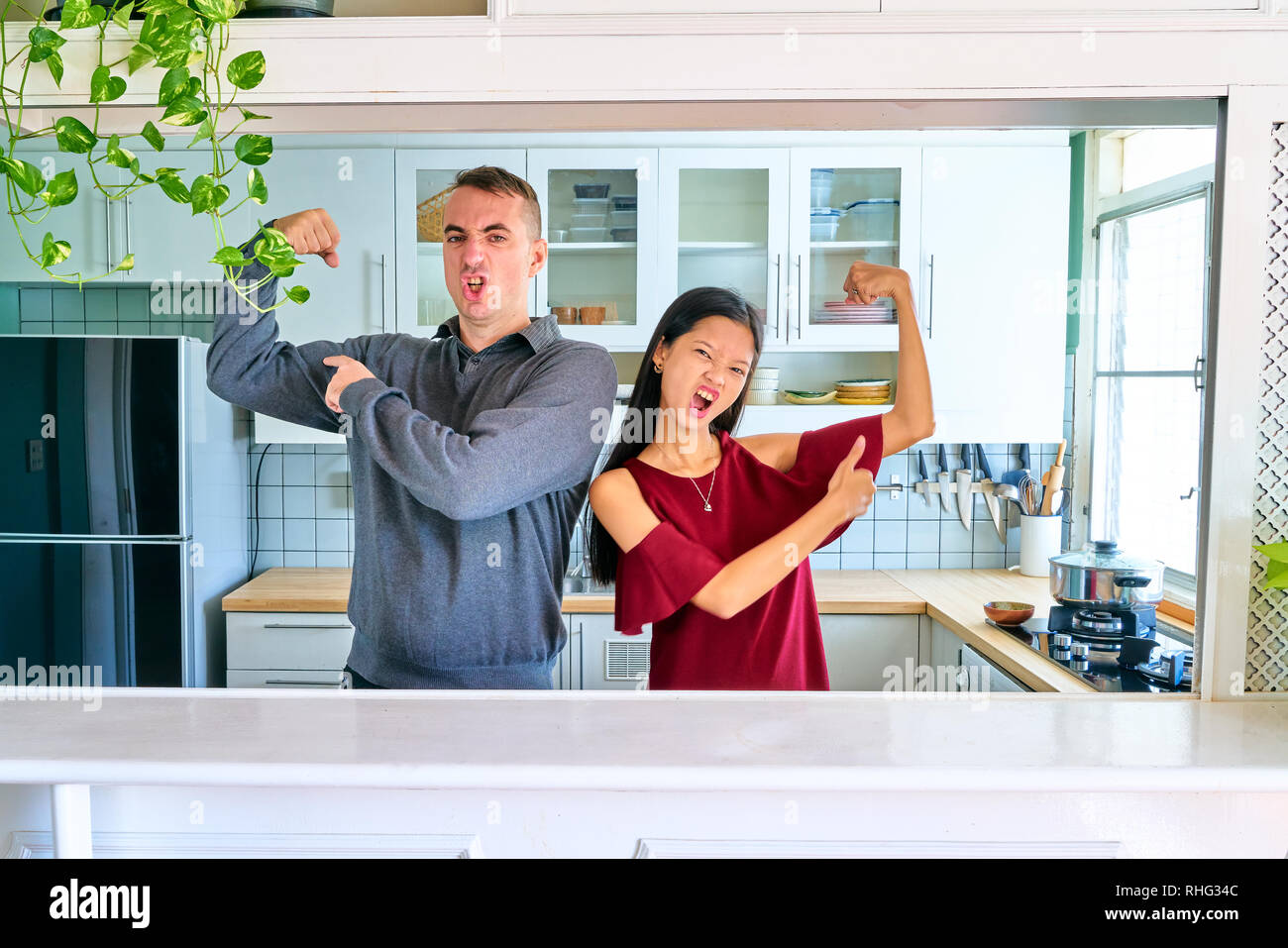 Lovely couple posing - showing there biceps Stock Photo - Alamy
