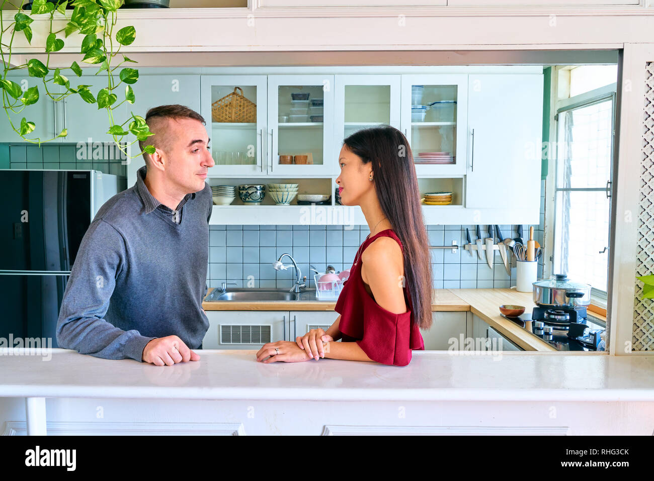 Lovely couple posing - talking each other Stock Photo - Alamy