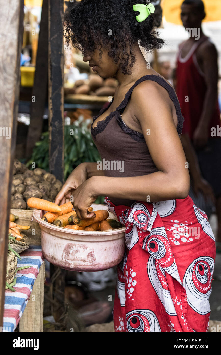 Toliara, Madagascar - January 10th, 2019: Young malagasy woman putting ...