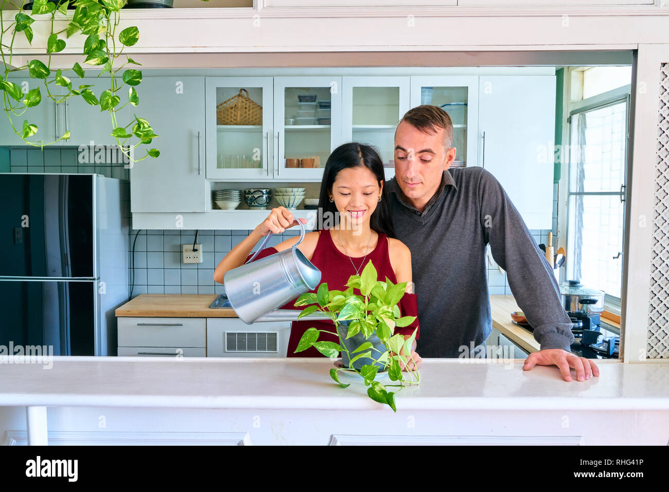Lovely couple posing - watering plants and taking care the plants Stock ...