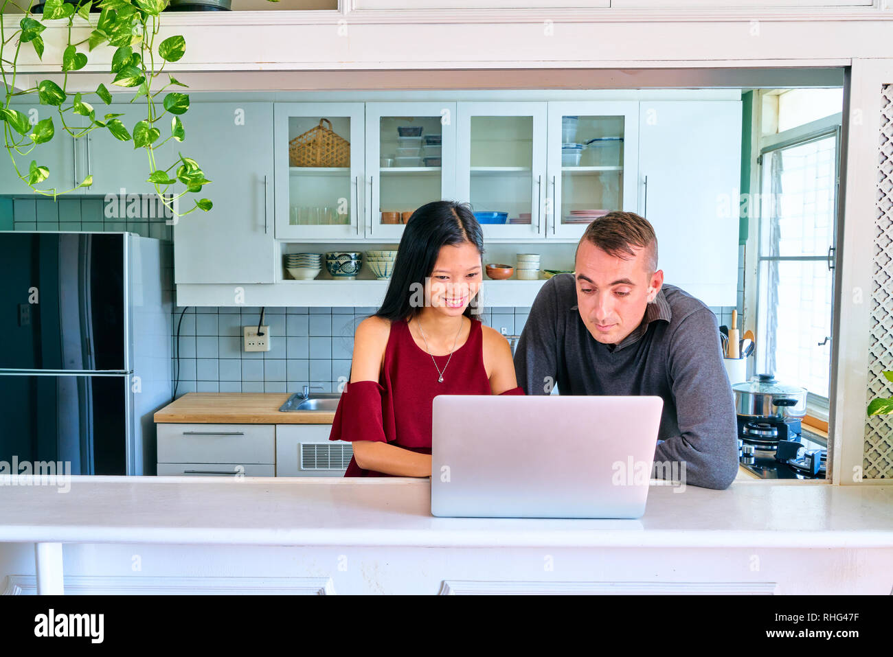 Lovely couple posing - searching something on laptop Stock Photo - Alamy
