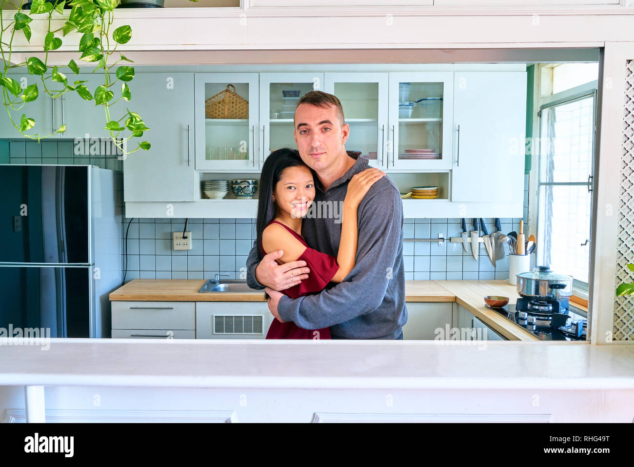 Lovely couple posing - hugging and looking at camera Stock Photo - Alamy