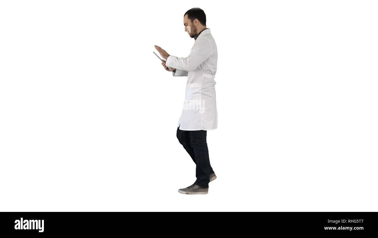 Doctor using tab while walking on white background Stock Photo - Alamy