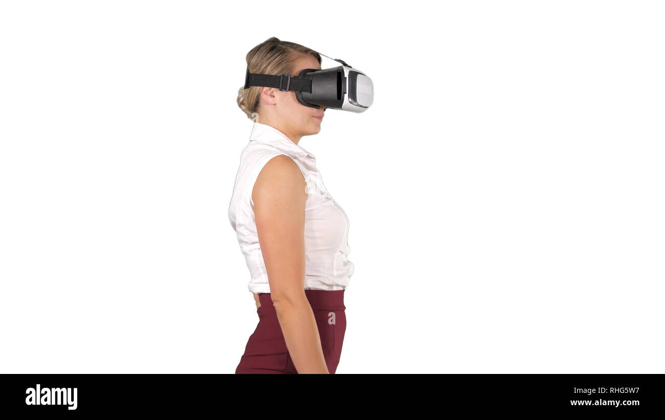Woman in VR headset walking on white background Stock Photo - Alamy