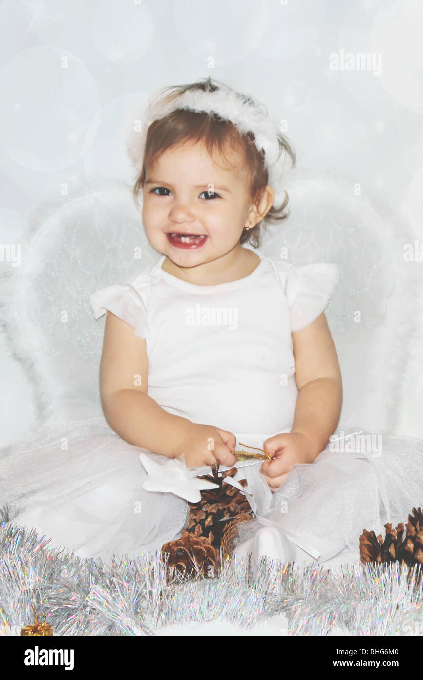 little child in the costume of an angel. Selective focus Stock Photo ...
