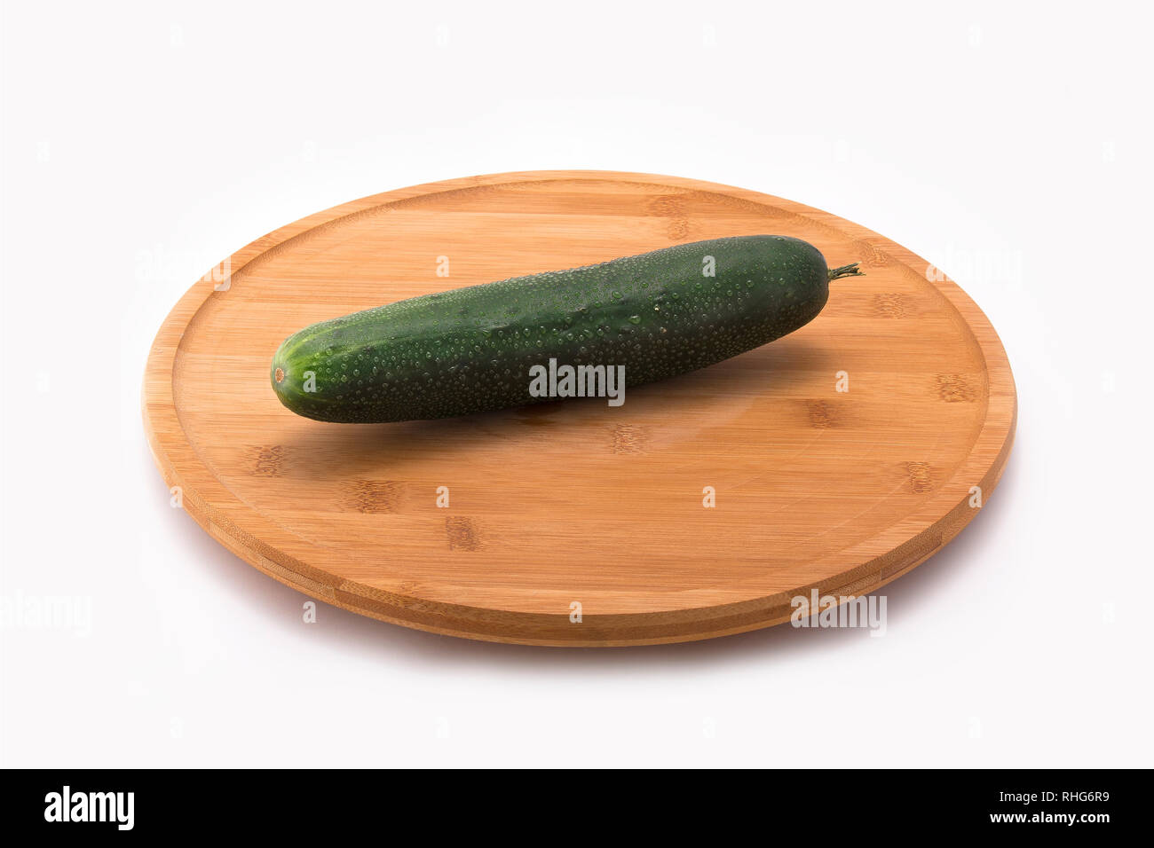 Fresh Cucumber wooden plate, white background Stock Photo - Alamy
