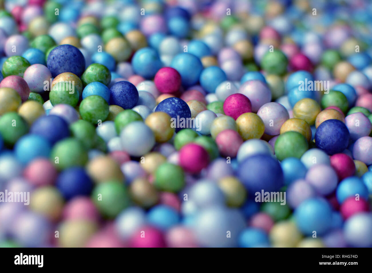 Colorful ball background made up of many small mostly blue foam balls ...
