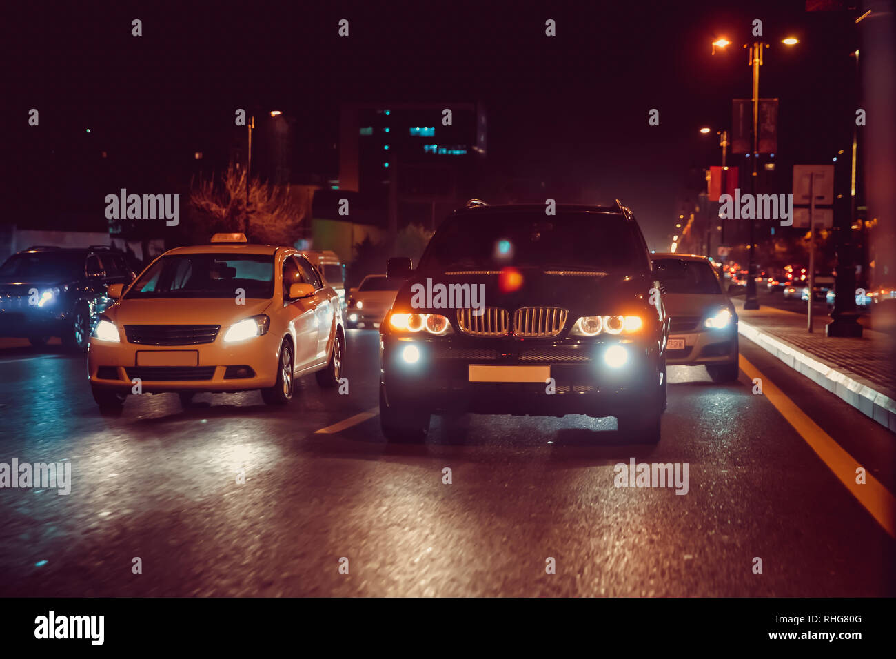 Night view of the cars. Road in the city at the night with yellow and ...