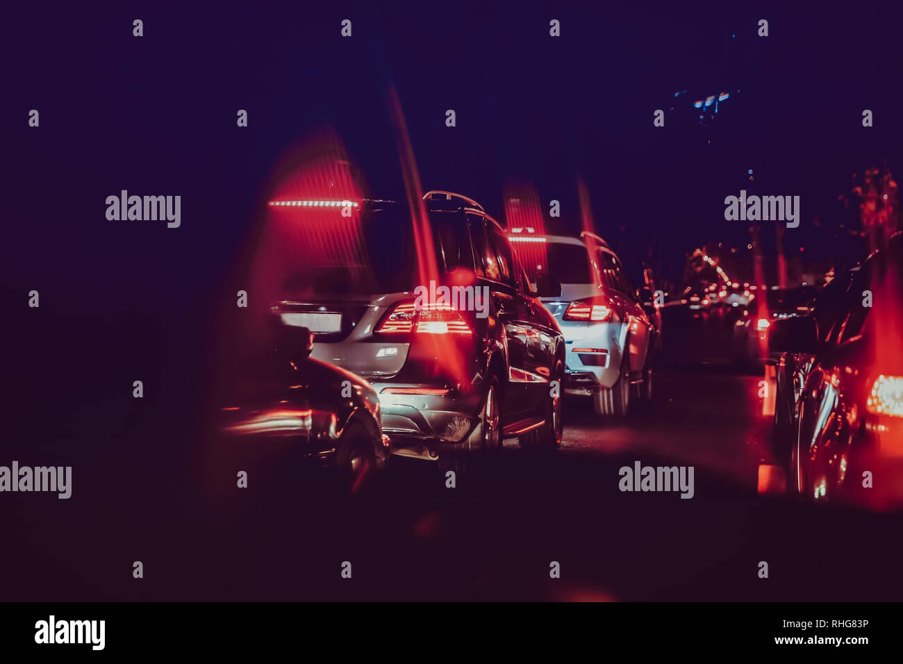Cars in the night traffic jam . Looking behind the cars.Cars are red ...