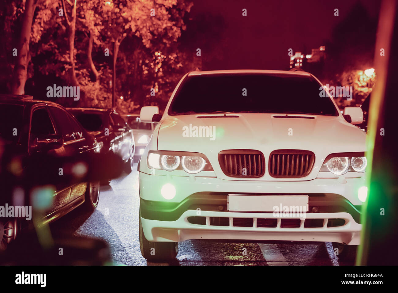 Night view of the white cars. Road in the city at the night with yellow ...