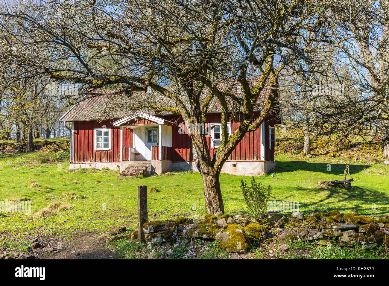 Old abandoned red cottage with garden in spring Stock Photo - Alamy