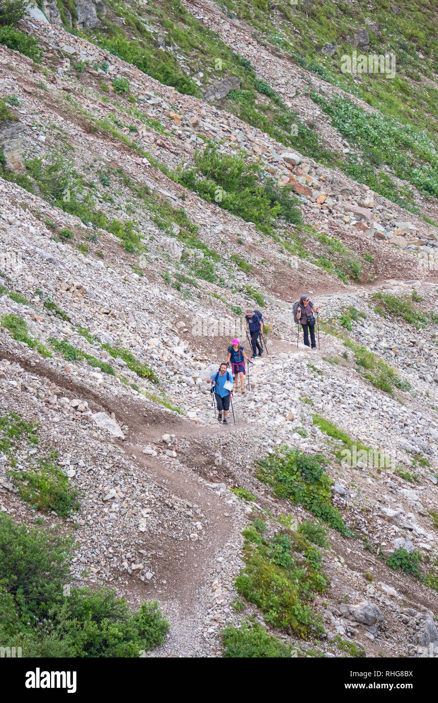 Family walking on a path on mountain slope Stock Photo - Alamy