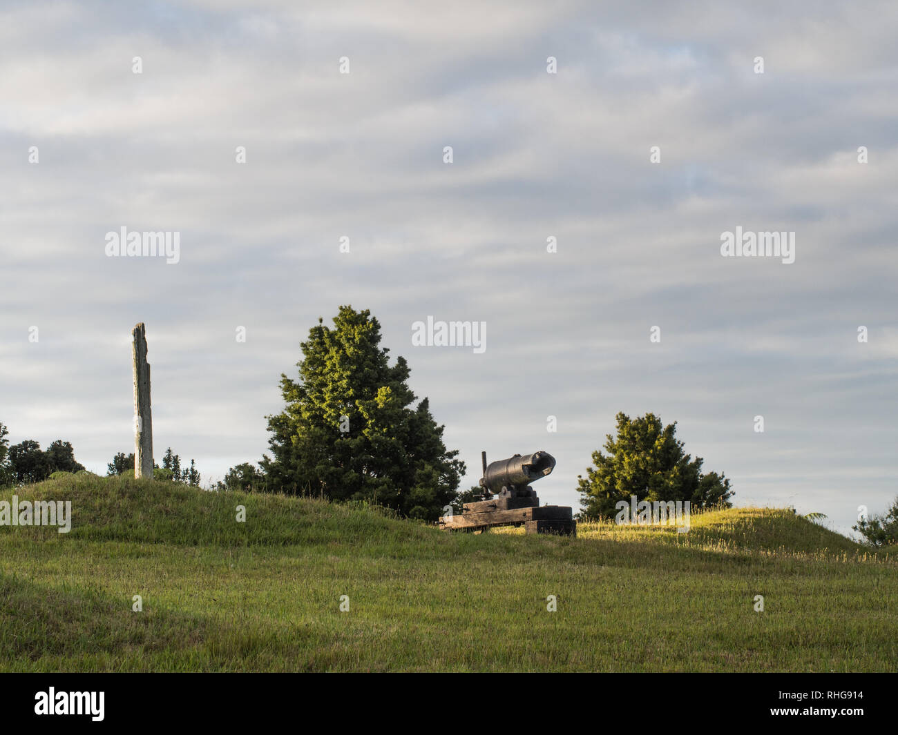 Pou whenua carved wooden post, and broken cannon, mounds and hollows ...