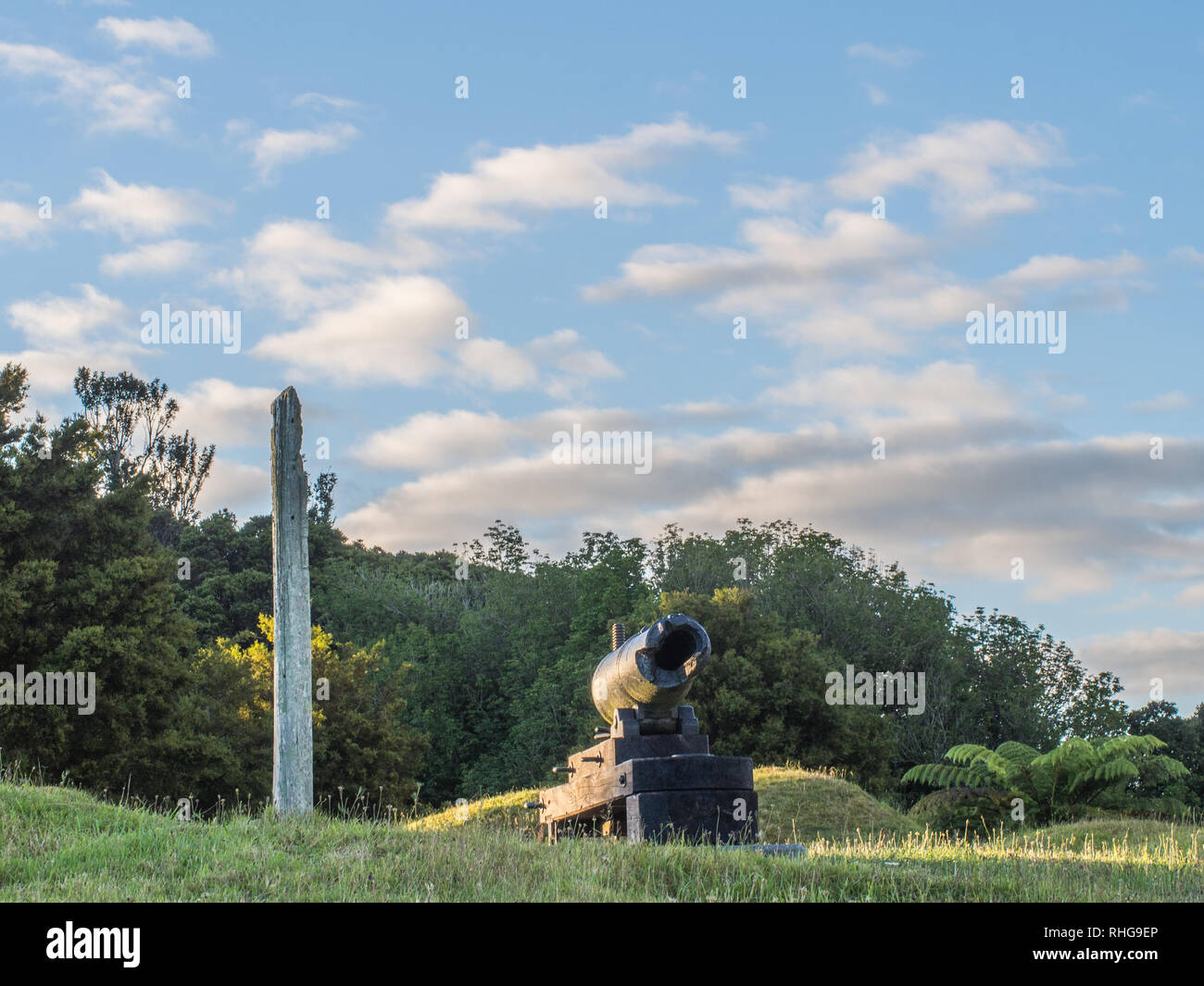 Pou whenua carved wooden post, and broken cannon, mounds and hollows ...