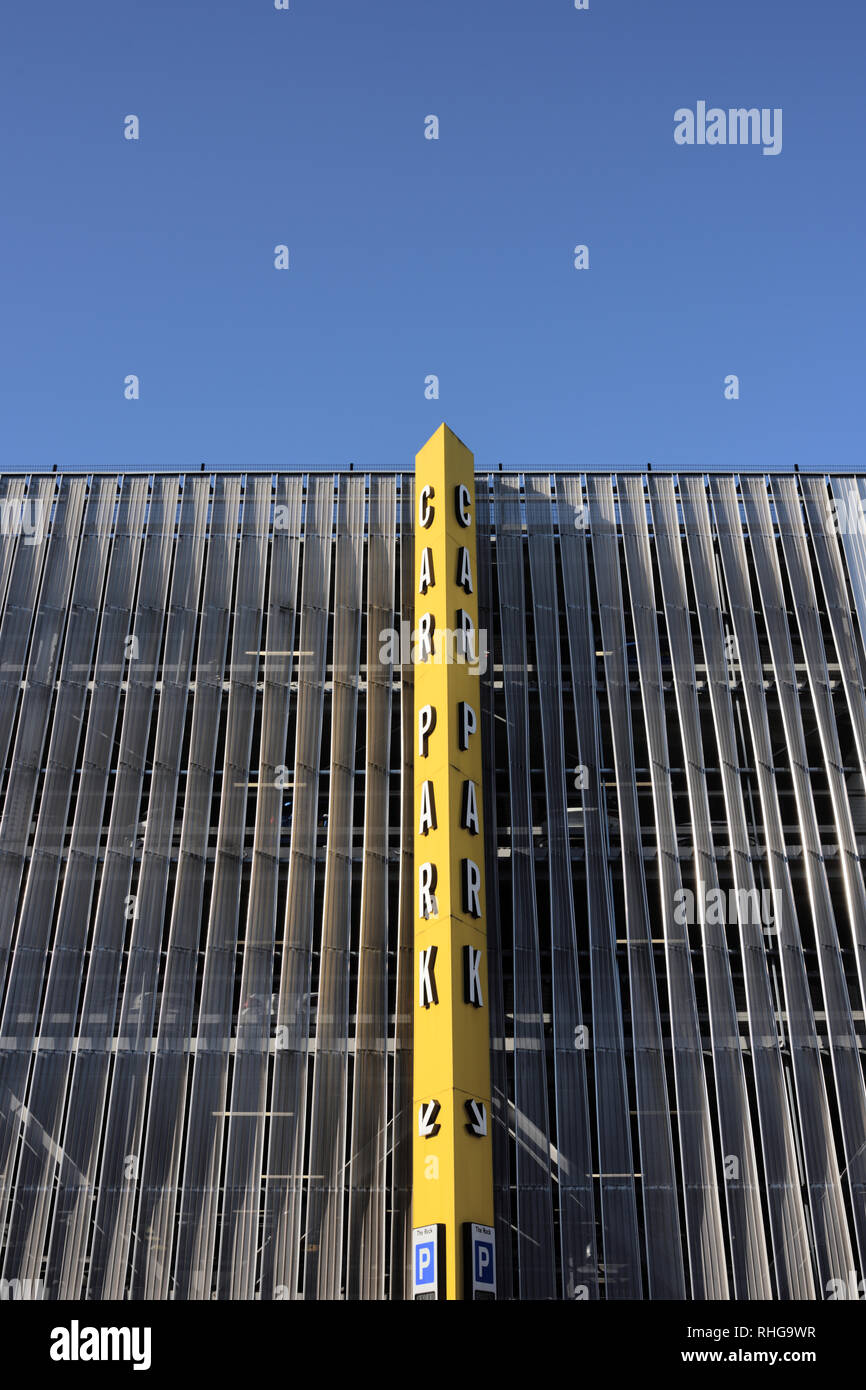 Multi storey car park with metal cladding and exterior vertical signage ...