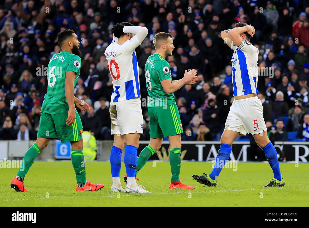 Brighton & Hove Albion's Lewis Dunk (right) looks dejected after ...