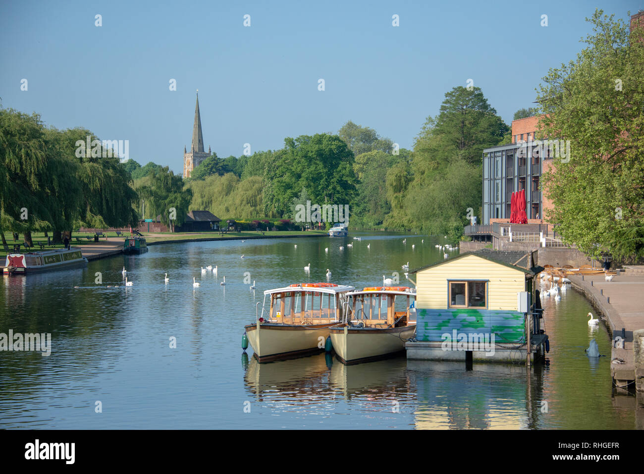boats on the river in a typical English scene with church and trees in ...
