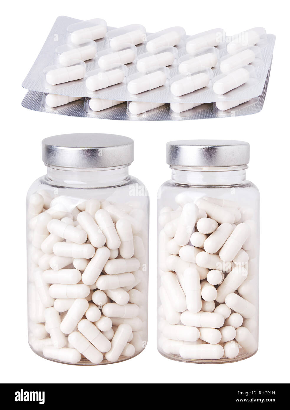 Set of white capsules in transparent glasss bottle and capsules in ...