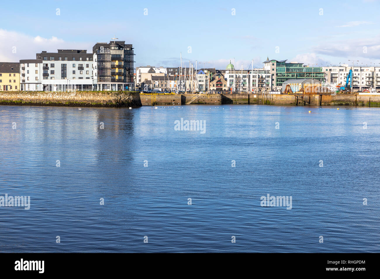 Galway harbour, Corrib river and Galway buildings with reflection ...