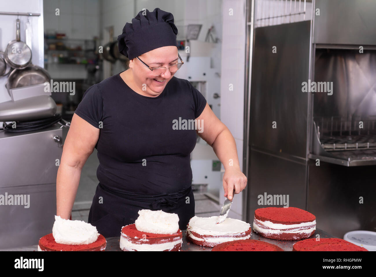 Woman pastry chef smiling and working happy, making cakes at the pastry ...