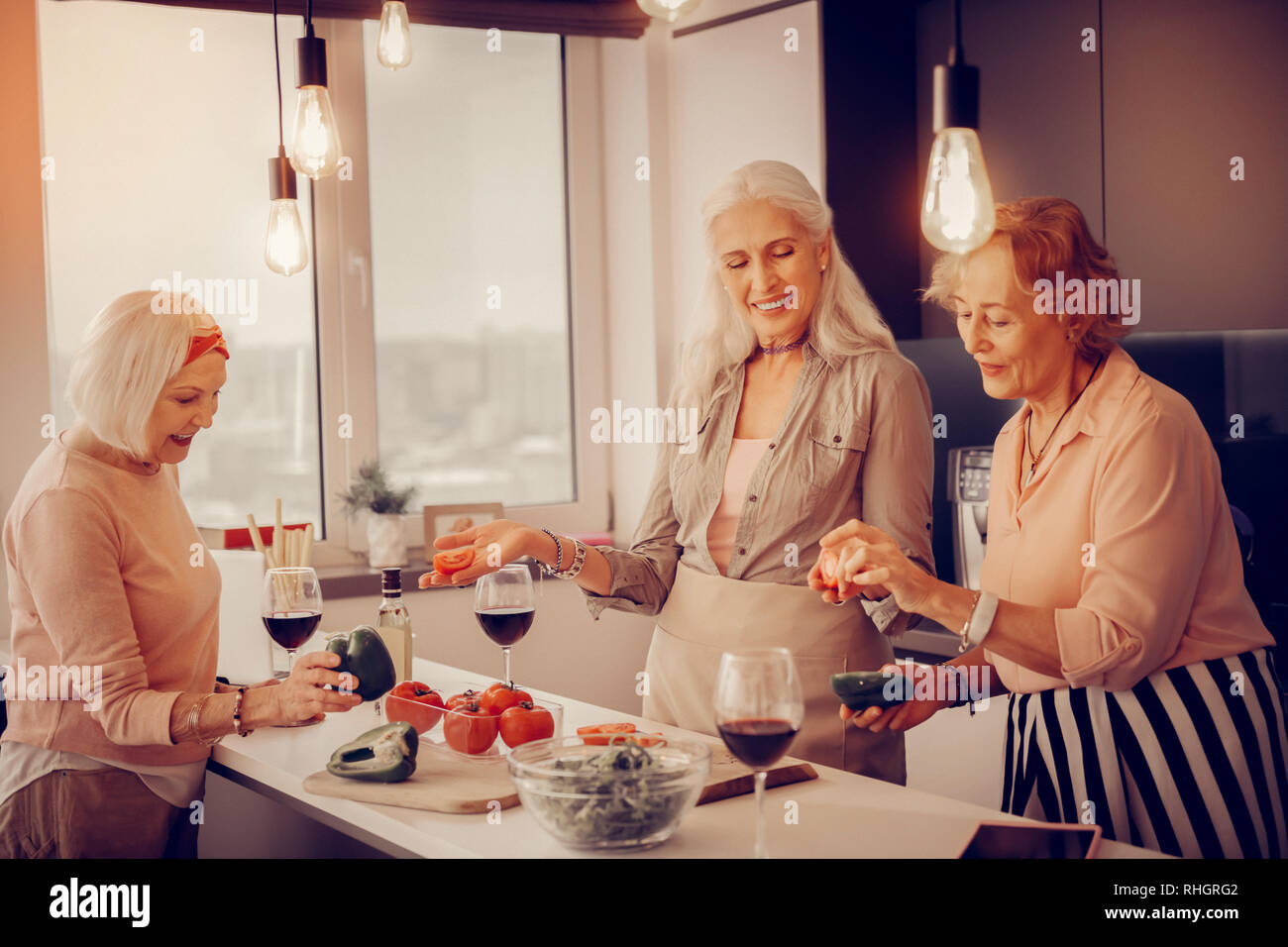 Happy nice women enjoying the cooking process Stock Photo - Alamy