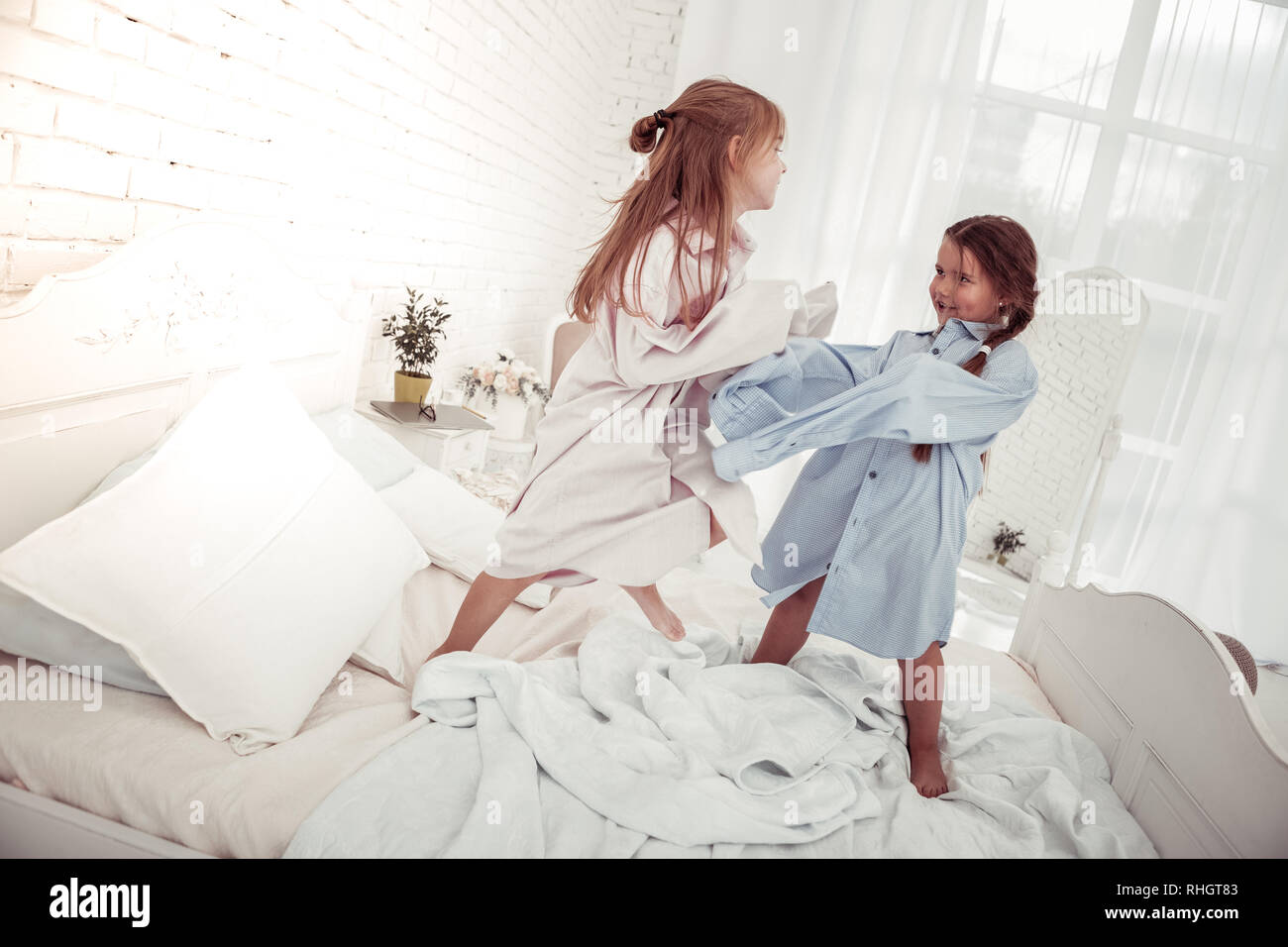Cheerful cute girls looking at each other Stock Photo - Alamy