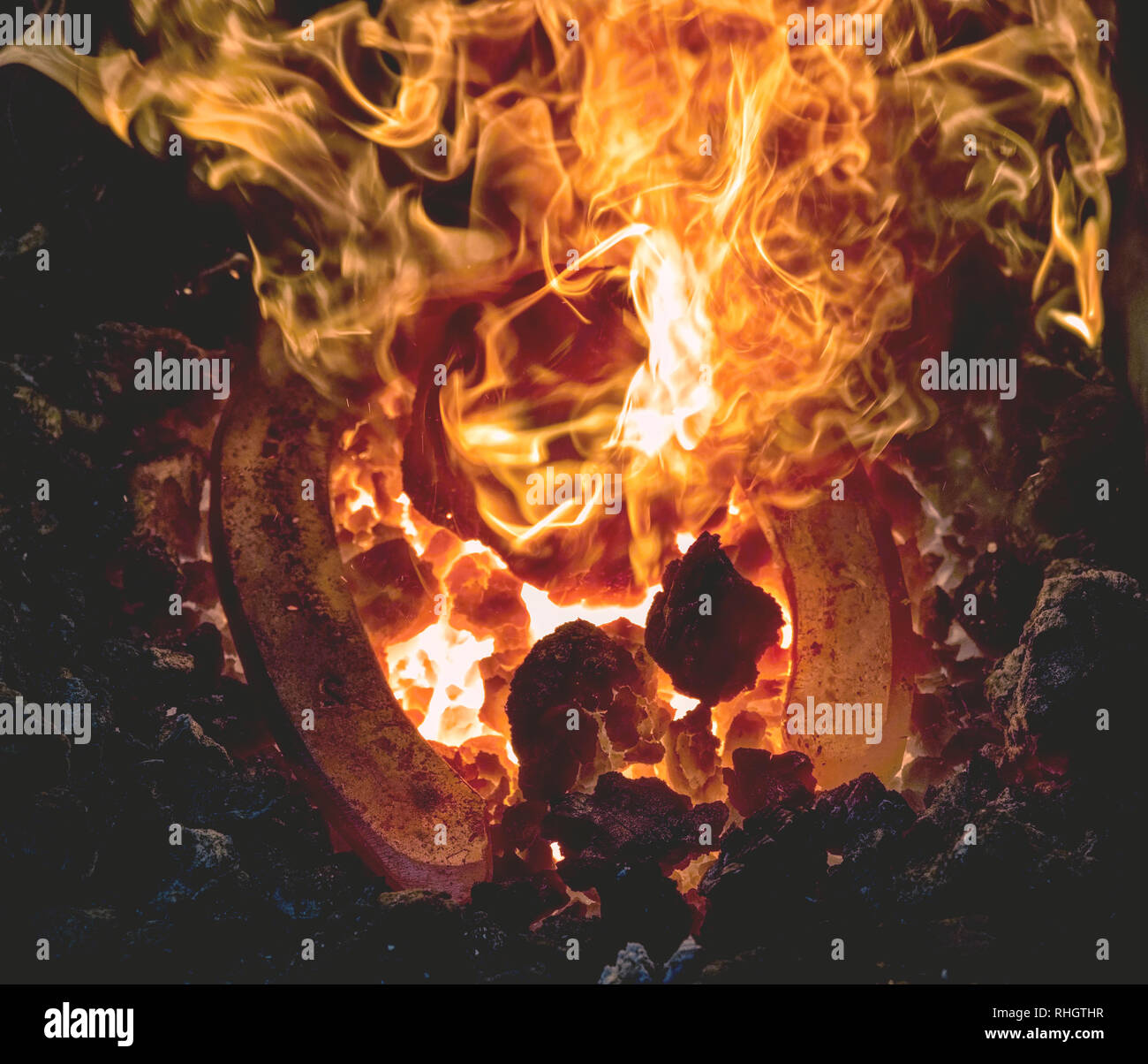 Heating of horseshooe. Mobile fireplace - coal forge with extremly hot ...