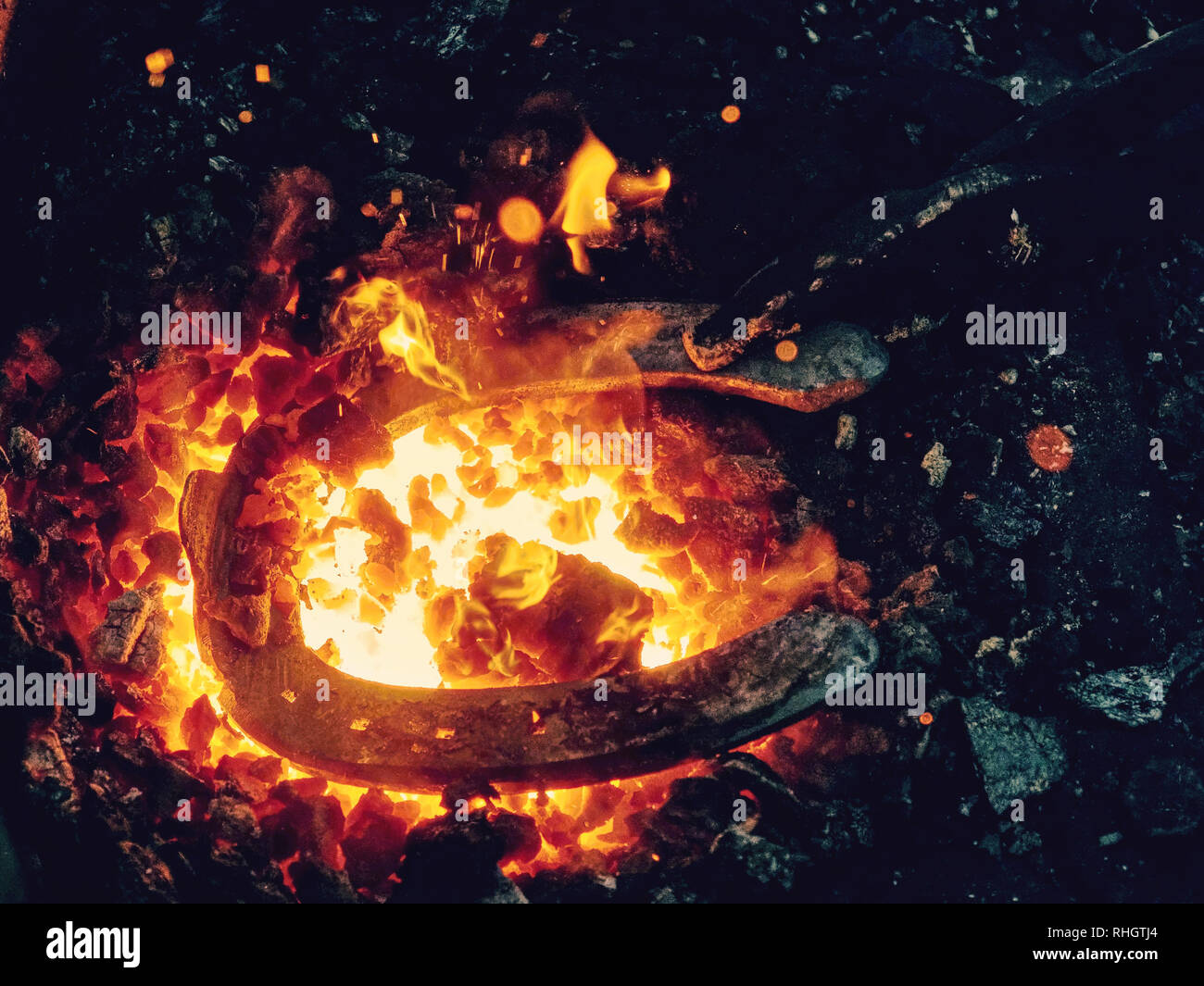Red fire blazes inside of coal forge. Blacksmith traditional works with ...