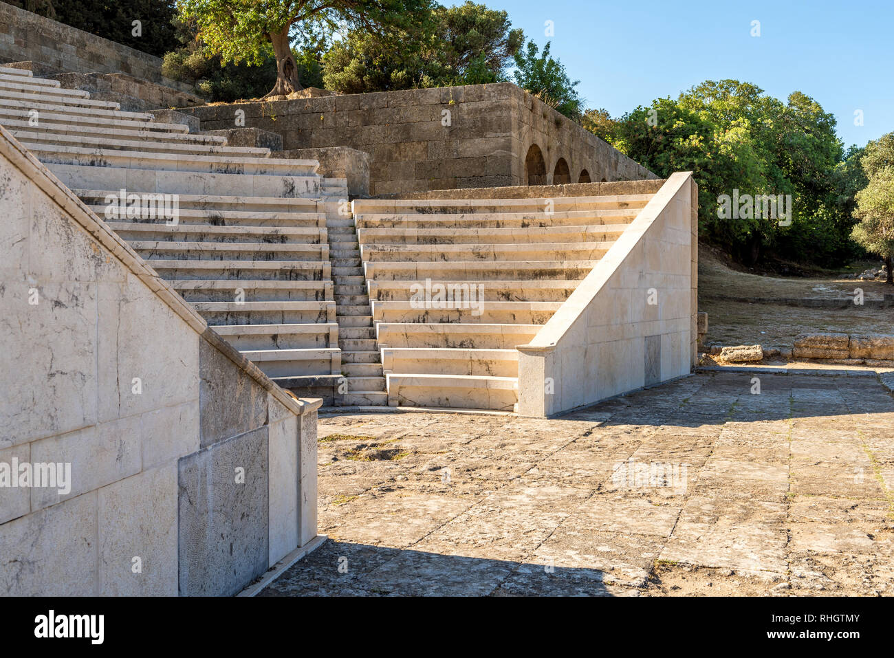 Ancient theater with marble seats and stairs. The Acropolis of Rhodes ...