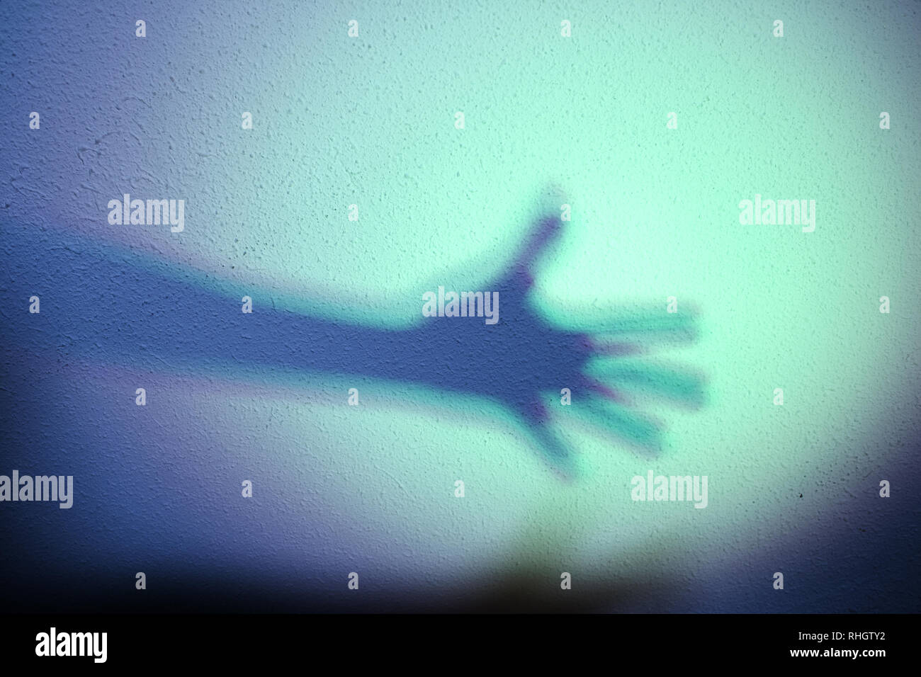 Extended arm with shadow in color, feeling of loneliness Stock Photo ...