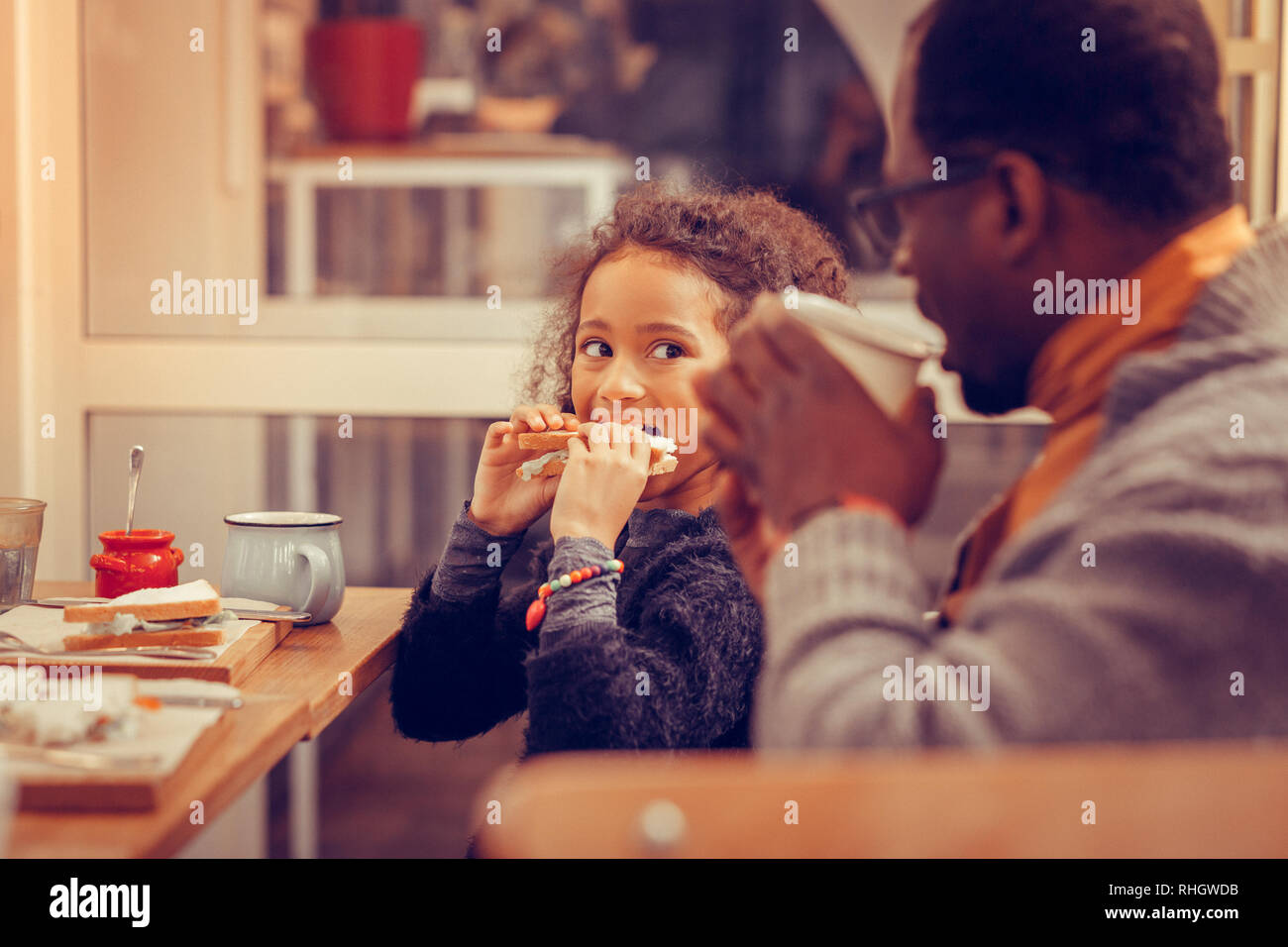 Girl looking funny while feeling hungry and biting her sandwich Stock ...