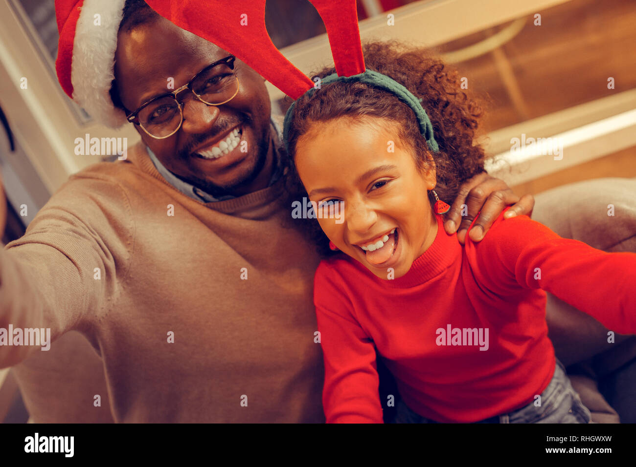 Cheerful father and daughter feeling excited celebrating Christmas ...
