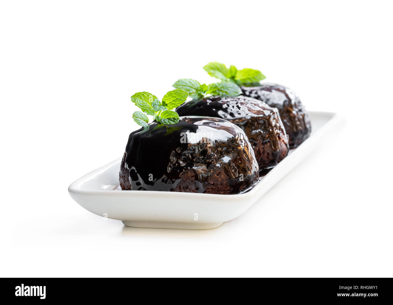 Sticky chocolate puddings isolated on white Stock Photo - Alamy