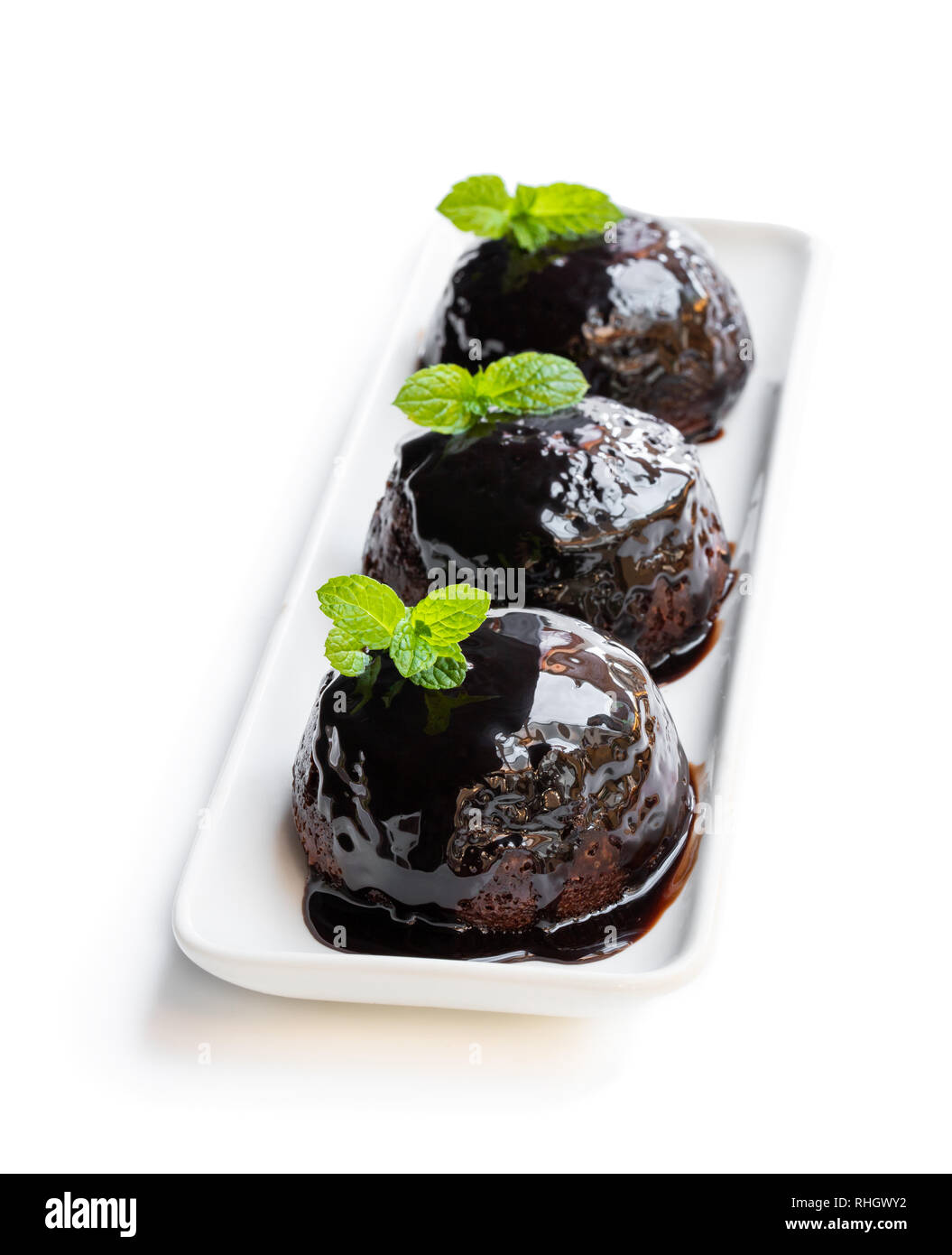 Sticky chocolate puddings isolated on white Stock Photo - Alamy