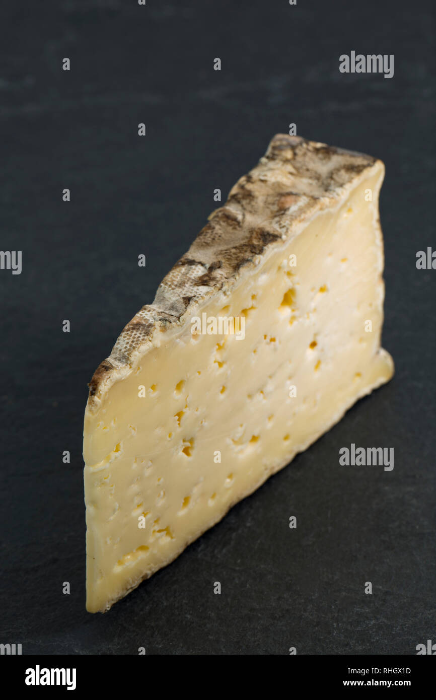 A wedge of Stoney Cross cheese made in the New Forest in Hampshire from ...