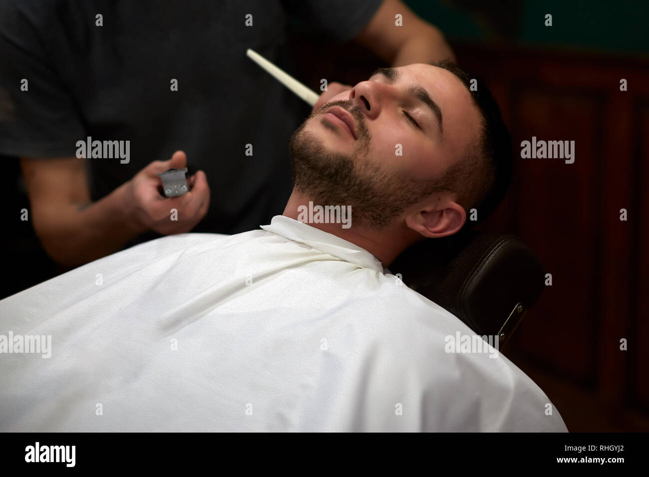 Close-up side view portrait of handsome young bearded Caucasian man ...
