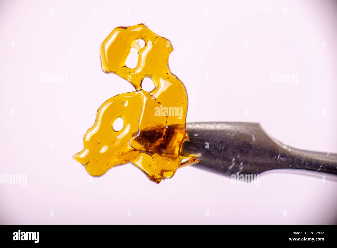 Macro detail of dab tool with cannabis concentrate aka shatter isolated ...