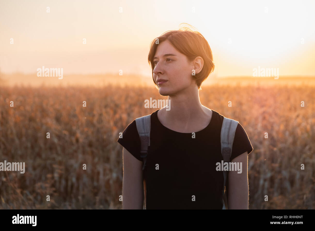 Backlit portrait of a woman in sunset. Female person standing in ...