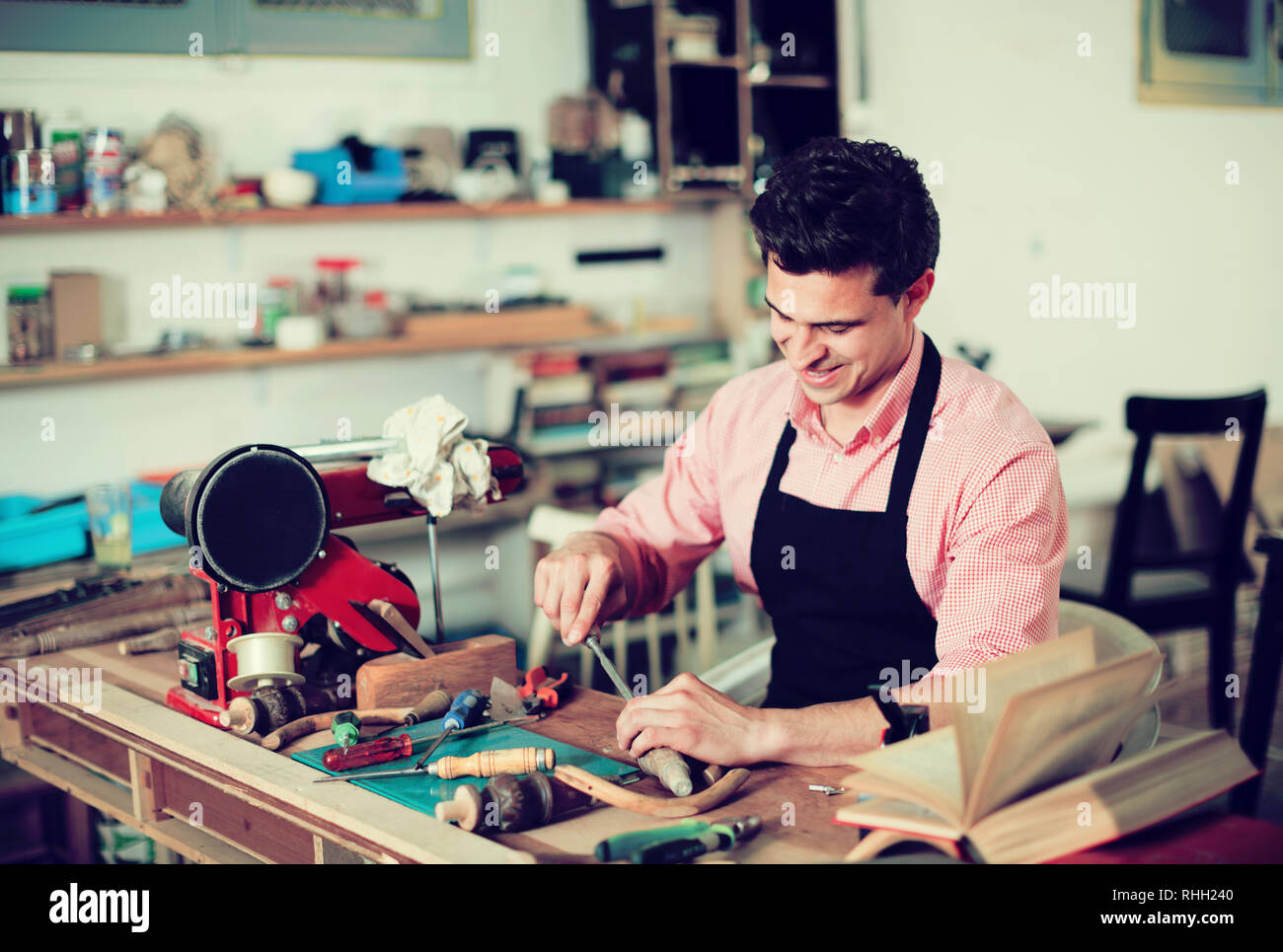 Portrait of serious craftsman in uniform working in carpentry Stock ...