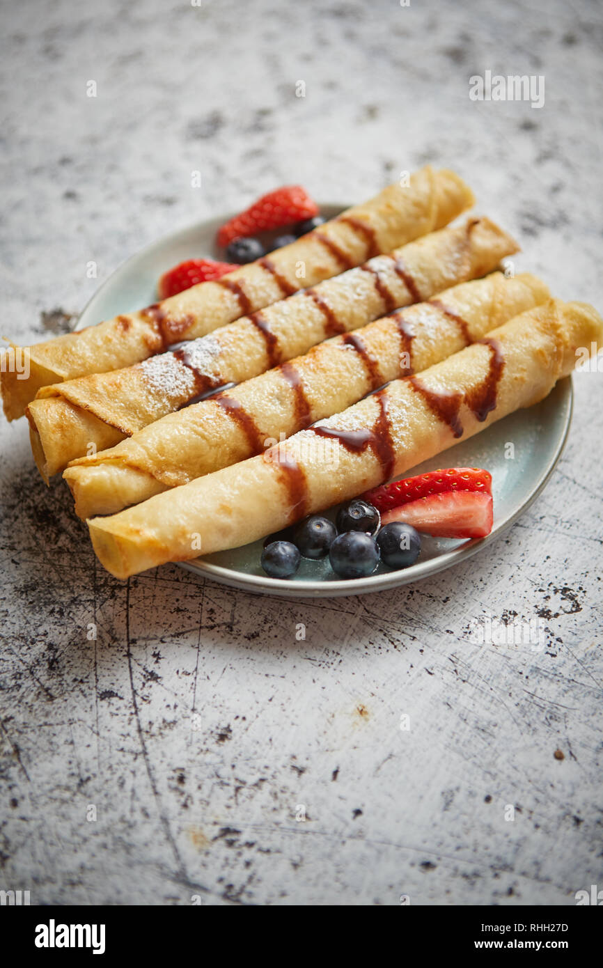 Plate of delicious crepes roll with fresh fruits and chocolate Stock ...