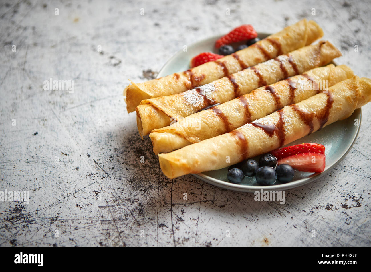 Plate of delicious crepes roll with fresh fruits and chocolate Stock ...